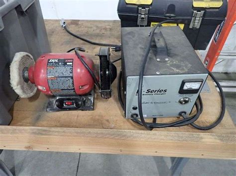 E Series Scr Battery Charger With Skil Buffer On Wood Table Yellow Tag Auctions
