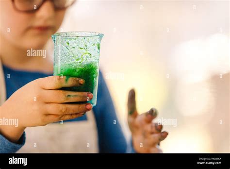 Girl Doing Science Experiment Holding Flask Of Green Liquid Stock Photo Alamy