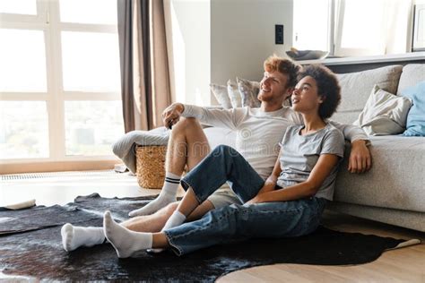 Young Beautiful Happy Smiling Interracial Couple Watching Tv Together