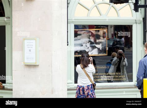 A Portrait Of Queen Elizabeth Ii Is Displayed In The Shop Window