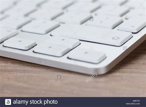 Low Angle View Of A Laptop Keyboard With Focus To The Shift Key And Copy Space Below On A Wooden