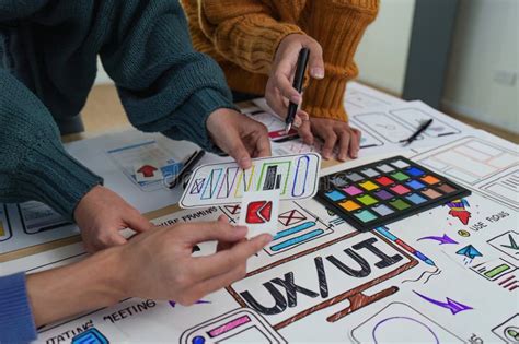 close up ux developer and ui designer brainstorming interface wireframe
