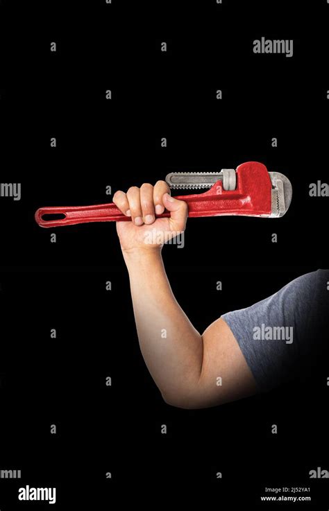 Arm Of A Man Showing Muscle With A Socket Wrench On A Black Background Labor Day Concept Stock