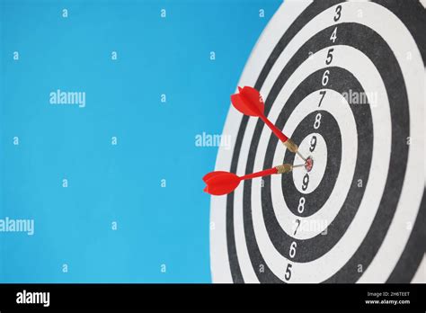 Two Red Dart Arrows Hitting In Target Center Of Round Dartboard Stock Photo Alamy