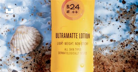 A Tube Of Sunscreen Next To A Sea Shell Photo Free Sunscreen Image On