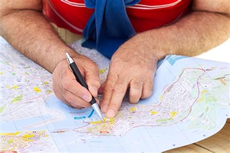 Premium Photo Midsection Of Man Pointing On Map At Table