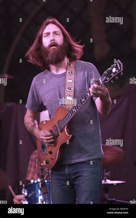 Musician Chris Robinson Is Shown Performing On Stage During A Live