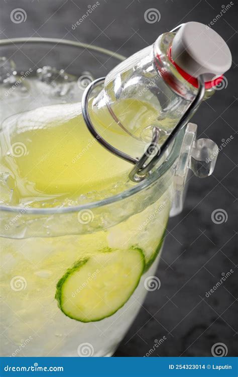 Lemonade With Cucumber Is Served In A Bottle With Mint In A Bucket With