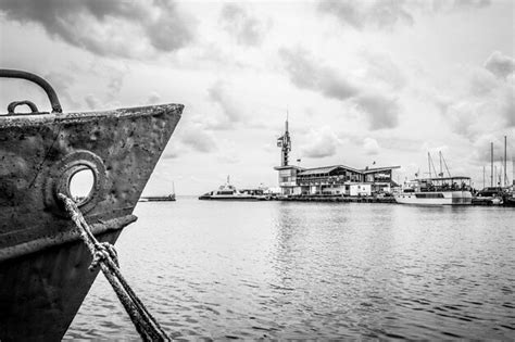 Premium Photo Ship Moored At Harbor Against Sky
