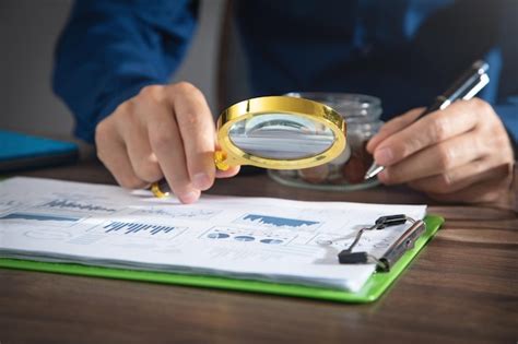 Premium Photo Man Holding Magnifying Glass With A Graphs And Charts