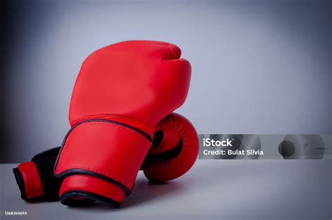 회색 배경 위에 빨간 권투 장갑 치열한 경쟁 환경의 비즈니스 상징으로 하나의 빨간 장갑에 함께 오는 블루 복싱 장갑의 그룹으로 도전을 극복 권투 스포츠에 대한 스톡 사진 및