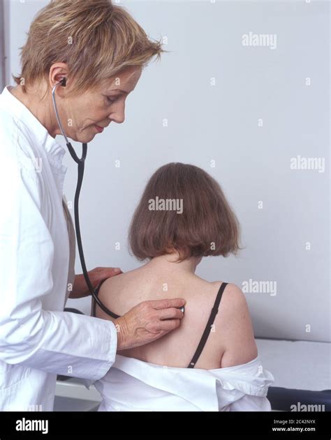 Doctor Listens To A Patients Lungs Stethoscope Examination Stock