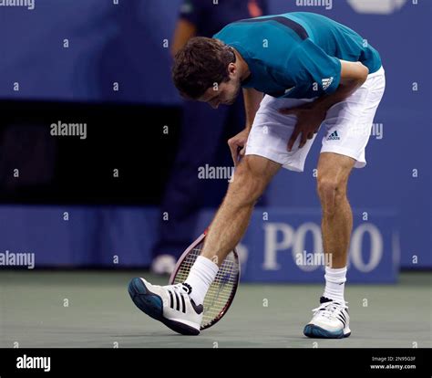 Gilles Simon Of France Stretches During A Match Against Mardy Fish At