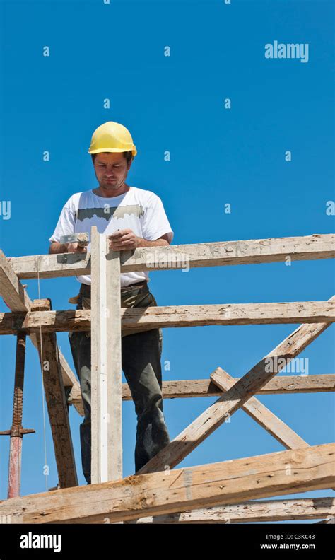 Construction Worker On Scaffold Busy With Formwork Preparation Stock Photo Alamy