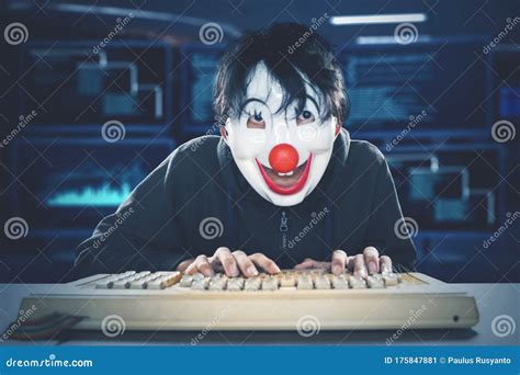 Male Hacker Working With Computer And Clown Mask Stock Image Image Of