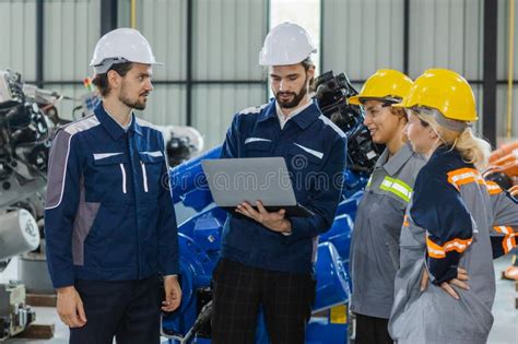 Engineers Working Robot Assembly Industry Plant In Factory Talking Meeting Examining