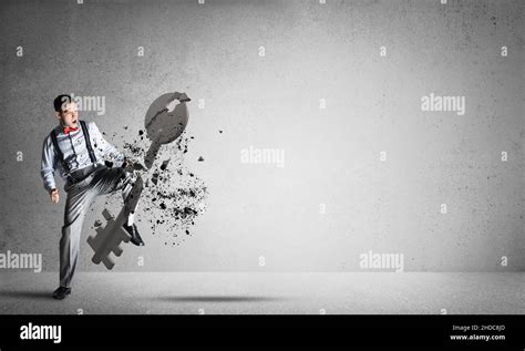 breaking through access concept with man in room crashing concrete key