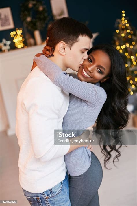 Beautiful Black Girl And White Guy Cuddling In The Living Room On