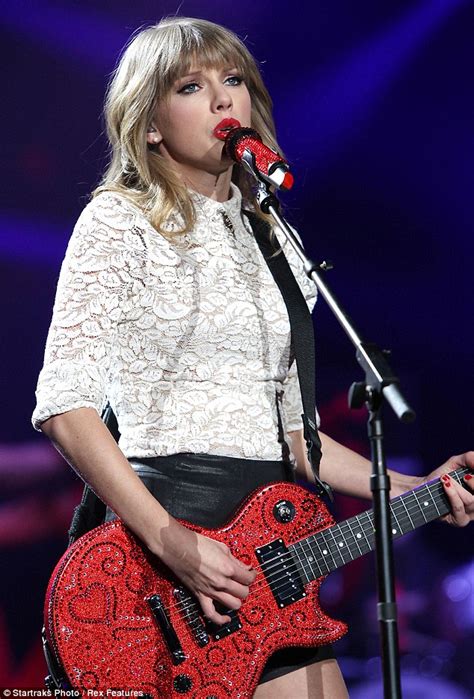 Taylor Swift Color Coordinates Tight Red Trousers With Splashy Orange