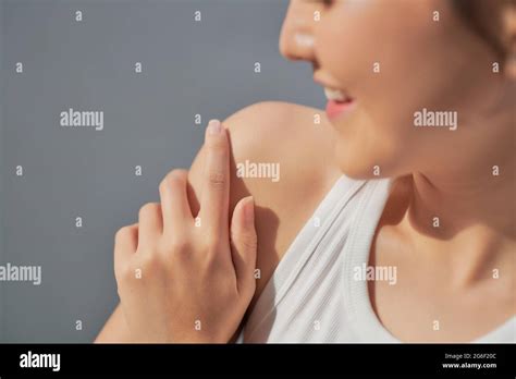 Young Skin Care Woman Applying Body Lotion On Arm And Shoulder At Home