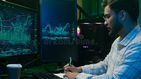 Indian Arabian Man Writing Notes Notebook Working With Pc Computer Trader Programmer Coder