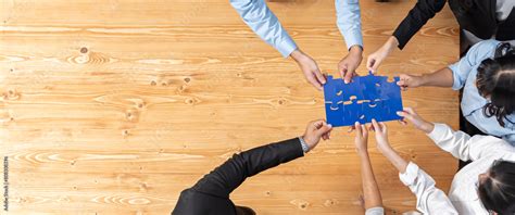 multiethnic business people holding jigsaw pieces and merge them