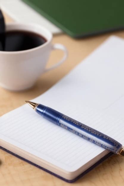 Premium Ai Image Focus Shot Of Pen And Notebook On Cozy Blurred Background