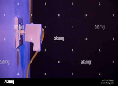 WiFi Extender In Electrical Socket On The Wall With Ethernet Cable Plugged In Stock Photo Alamy
