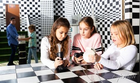 Portrait Of Focused Tween Girls Trying To Solve Conundrum In Posters For The Wall Posters