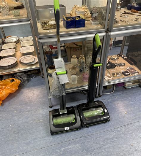 Two Gtech Cordless Hoovers With One Charger Untested Handle Repaired With Tape On One