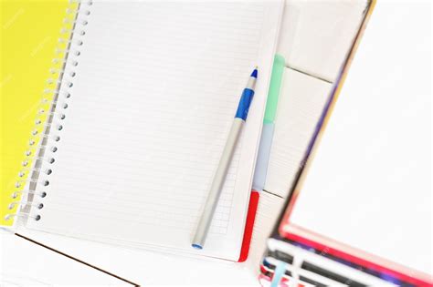 Premium Photo Open Blank Notepad With Pen And Stack Of Books White Table Working Space