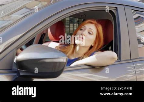 Aggressive Nervous Lovely Redhead Middle Aged Female Driver In Formalwear Stuck In Traffic Jam