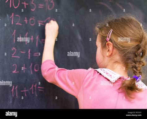 Schoolgirl Solving Simple Equations At School Stock Photo Alamy