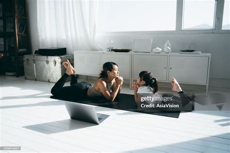 Joyful Young Asian Mother And Little Daughter Exercising And Practising Yoga Together At Home