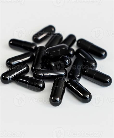 Collection Of Black Capsules Arranged On A White Background For Display