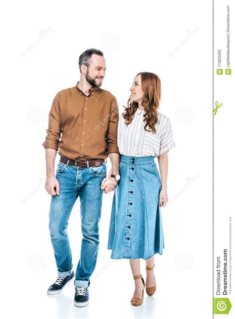 Full Length View Of Happy Couple Holding Hands And Smiling Each Other