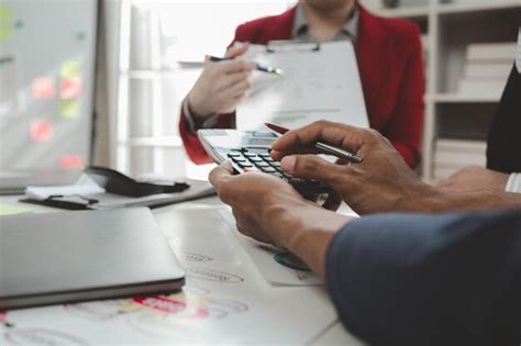 Premium Photo Calculate The Numbers According To The Report Sent To The Meeting They Are