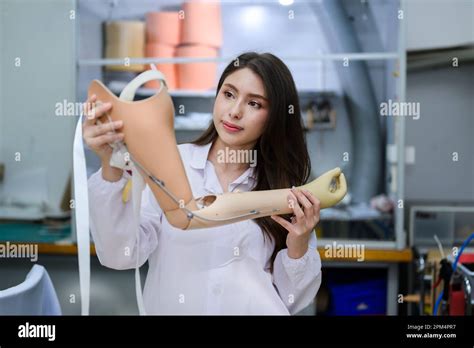 Prosthetic Technician Holding Prosthetic Arm Checking And Controlling