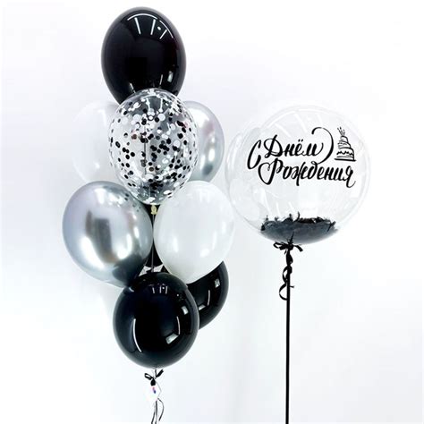 some black and white balloons are hanging on the wall