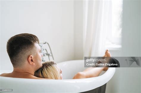Young Happy Couple In Love Taking Bath Together In Bathroom At Home