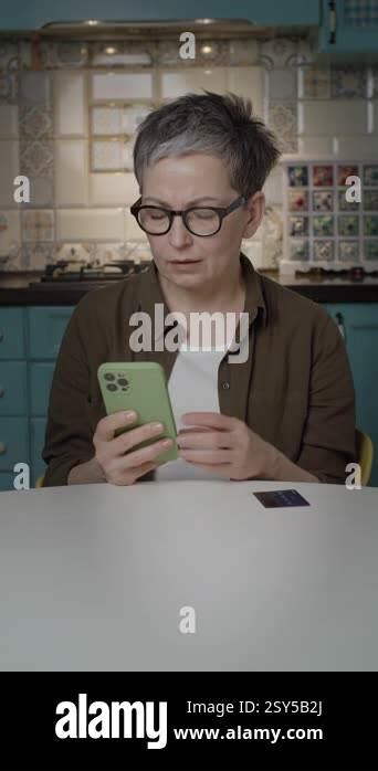 A Mature Woman Looks Frustrated While Trying To Complete An Online