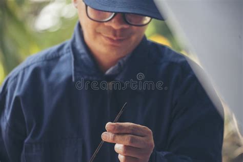 Car Mechanic Man Hand Checking Dipstick Engine Oil Car Mechanical On Site Service Close Up Hand