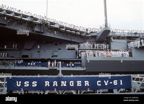 Crew Members Line The Railing Aboard The Aircraft Carrier Uss Ranger