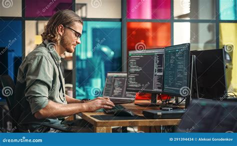 The Programmer Writes The Program Code At Night In A Dark Room Hands On Laptop Keyboard And