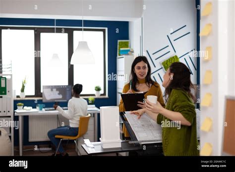 Team Of Businesswomen Standing In Creative Studio Office Discussing And