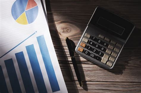 Premium Photo Statistical Graphs And Calculator With Pen On Table