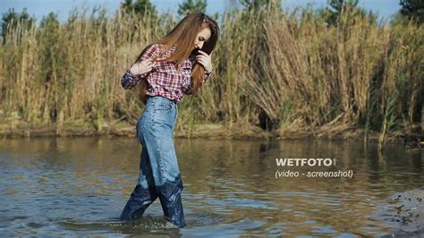 Swimming By Beautiful Girl In Soaking Wet Blue Jeans And Shoes On Lake