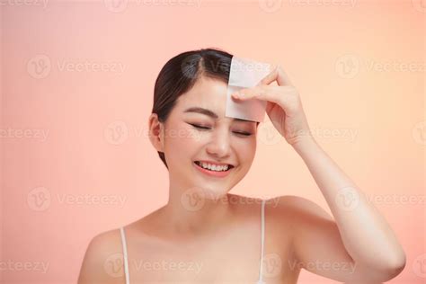 Woman Removing Oil From Face Using Blotting Papers Stock Photo At Vecteezy