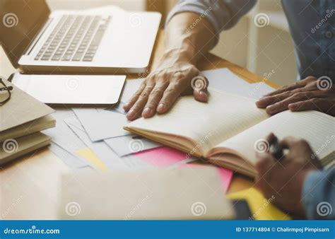 Two Confident Students Doing Homework Together While Sitting At The