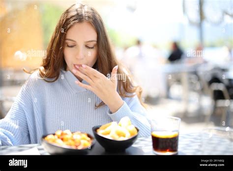 Restaurant Customer Eating And Licking Finger In A Terrace Stock Photo Alamy